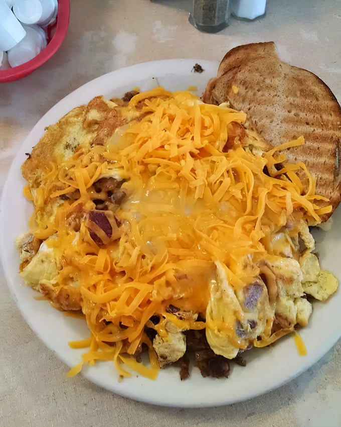 The Corned Beef Scrambler doesn't just feed you—it fortifies you for whatever the day might throw your way, crowned with a sunshine-yellow cheese blanket.