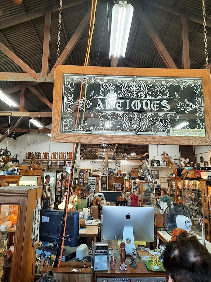 An ornate "Antiques" sign hangs like a chandelier, fancy enough to make your grandmother's crystal jealous.