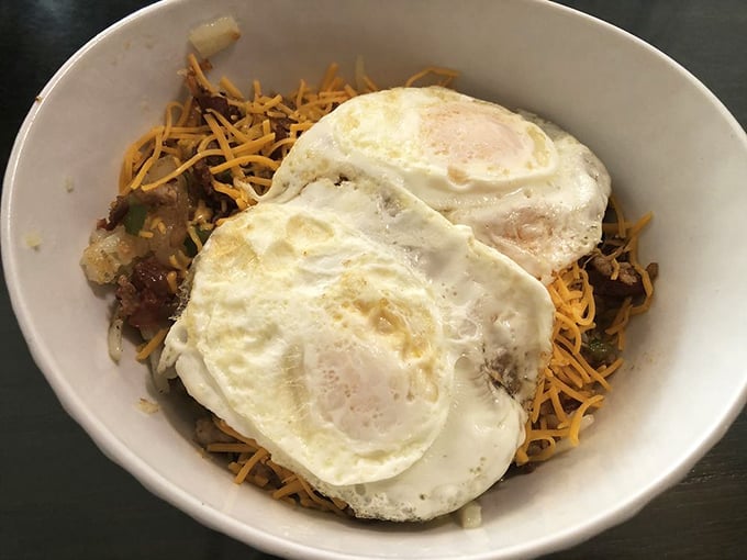 Two sunny-side-up eggs crown this skillet like royalty. The melted cheese underneath is the throne upon which breakfast greatness sits.