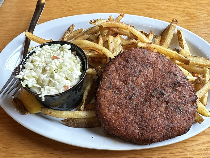 A crab cake that's actually about the crab, not the cake. Paired with those proudly "greasy" fries and homemade coleslaw—a holy trinity of satisfaction.