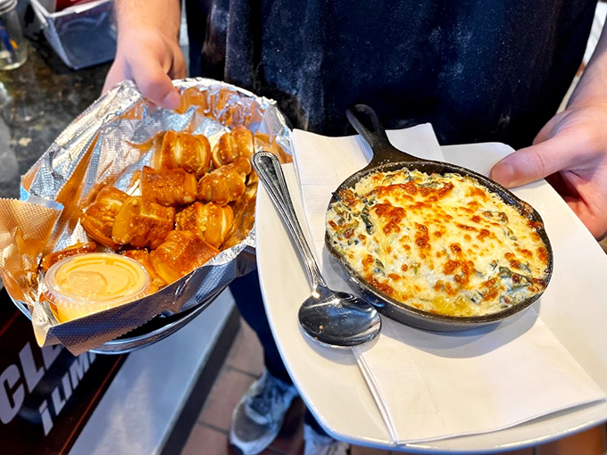Pretzel bites and bubbling crab dip—the kind of appetizer that makes you reconsider your entrée order because maybe this is all you need.