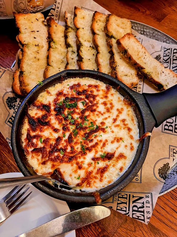 This bubbling crab dip with garlic bread is the kind of dish you'd cancel plans for—melty, golden, and worthy of devotion.