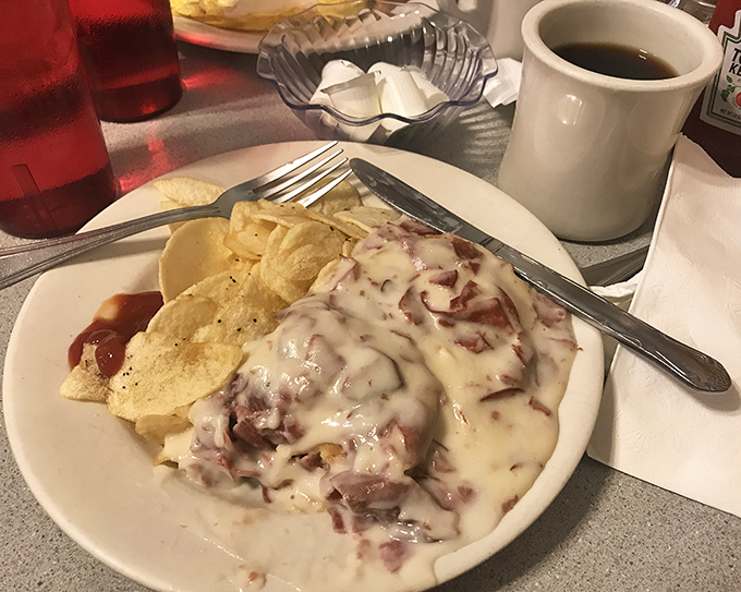 Cream chipped beef—the comfort food that time forgot everywhere else but thrives gloriously here, smothering potatoes under a blanket of savory goodness.