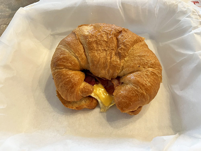 The humble croissant sandwich – proof that sometimes the simplest combinations create the most satisfying morning companions.