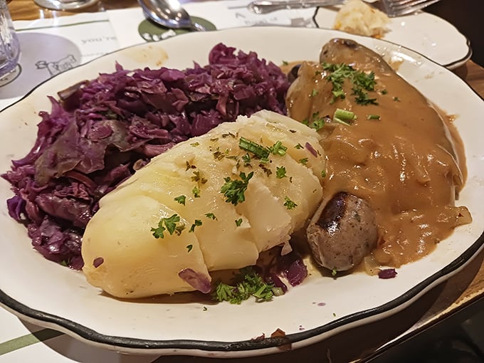 A plate that would make any Danish grandmother proud – tender potato dumplings nestled against purple cabbage and savory sausage swimming in rich gravy.