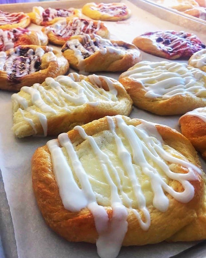 The glazed croissants huddle together like old friends sharing sweet secrets. Each one a testament to butter's higher purpose.