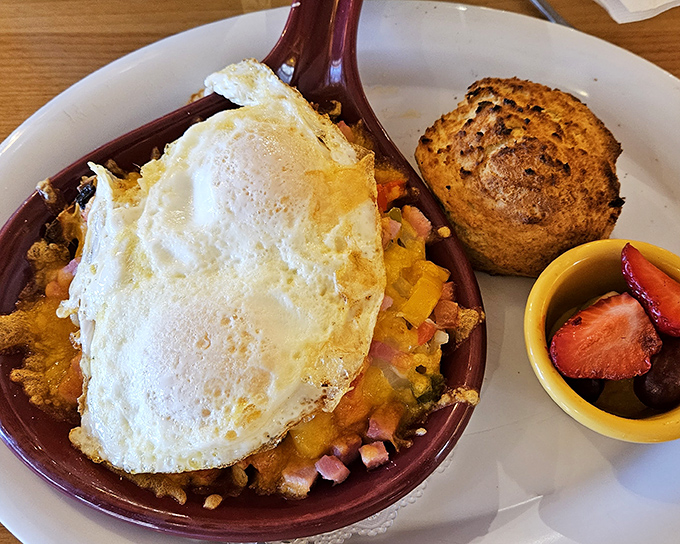 This Denver Skillet isn't just breakfast – it's an edible sunrise, with eggs crowning a mountain of savory ingredients in that signature burgundy dish.