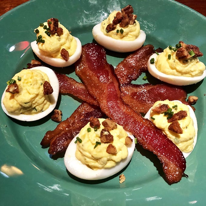 Deviled eggs with spiced pecans and sugar-cured bacon – proof that sometimes the best things in life come in small, eggy packages.