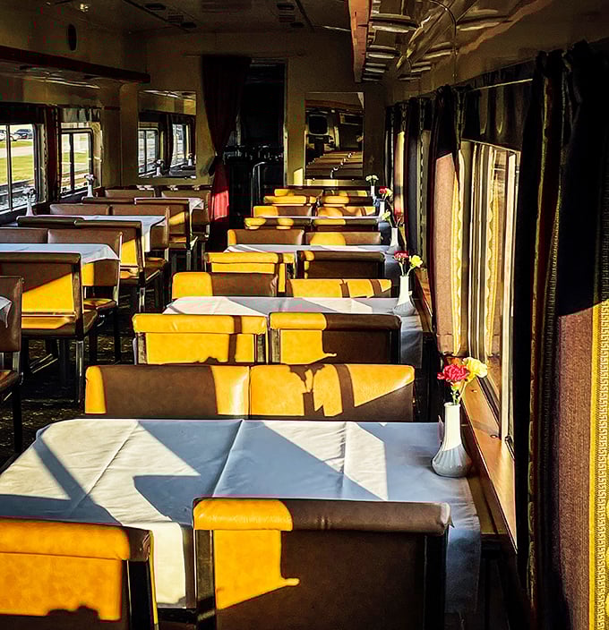 Dining car elegance awaits with tables dressed in crisp linens and sunshine streaming through the windows. Meals with a side of ever-changing scenery!