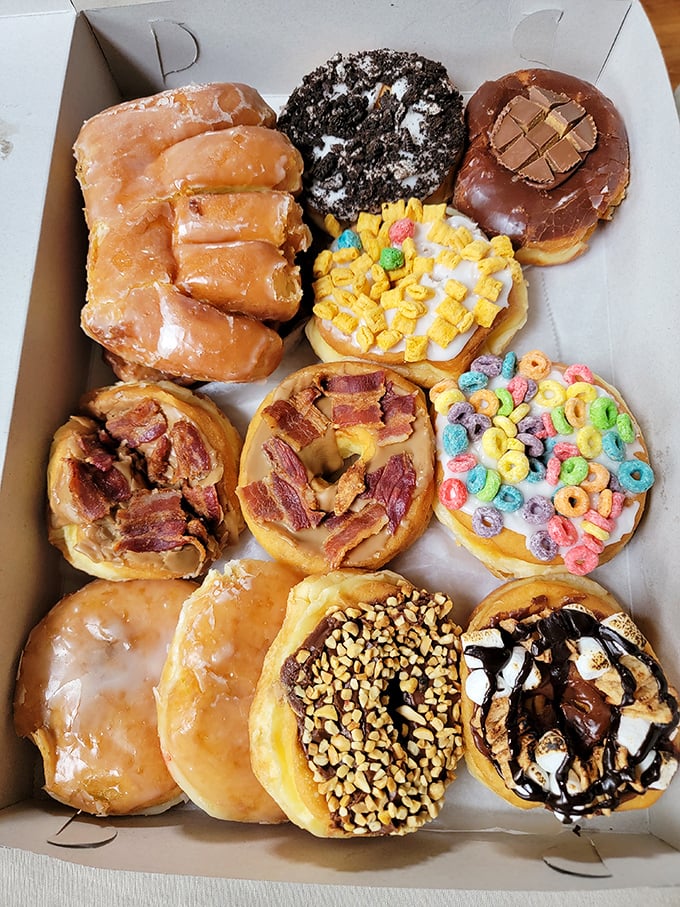 A box of joy containing more creativity than most art galleries—each donut a different expression of fried dough perfection.