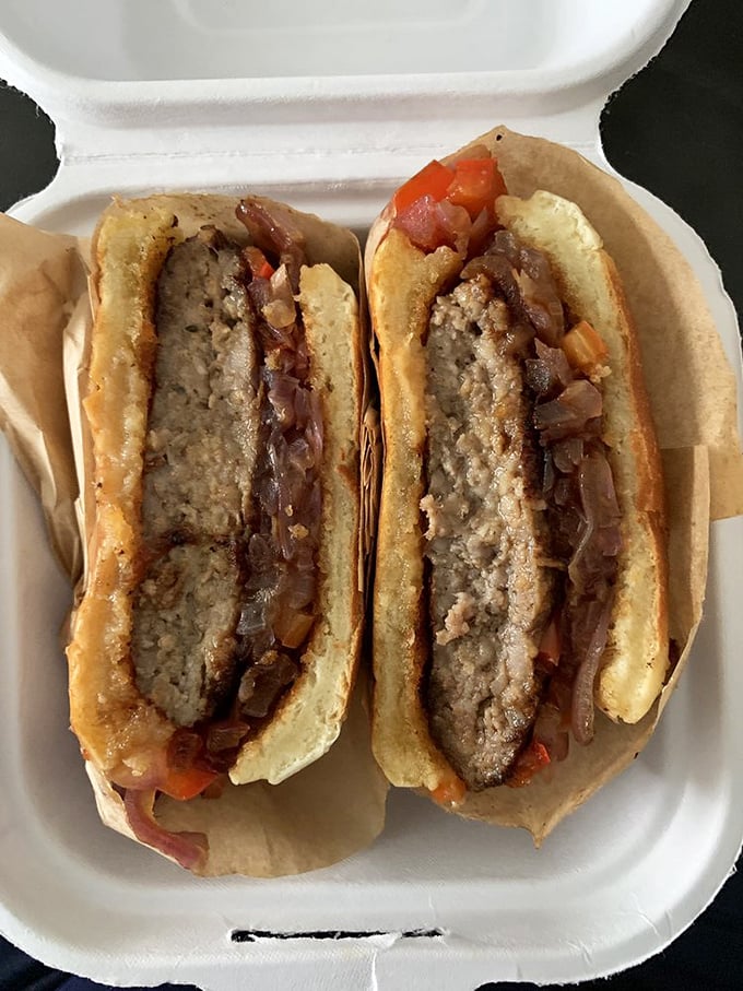 A sandwich so perfectly constructed it deserves its own architectural award—caramelized onions and sausage in harmonious balance like an edible symphony.