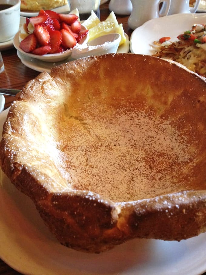 The Dutch Baby arrives like a crater on your plate – a German pancake phenomenon waiting for lemon, powdered sugar, and your undivided attention.