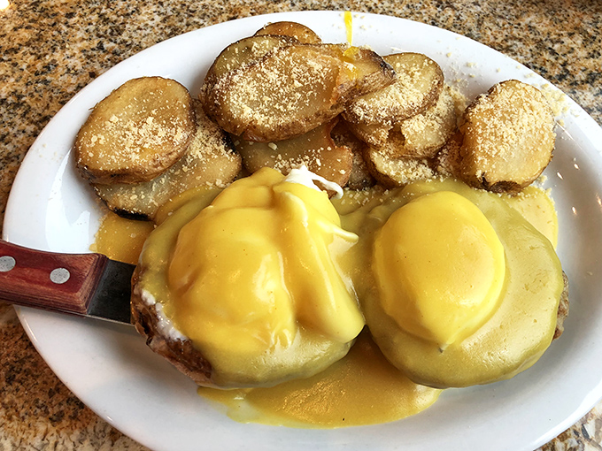 Eggs Benedict done right – golden hollandaise cascading over perfectly poached eggs like a sunrise over Newport's coastline.
