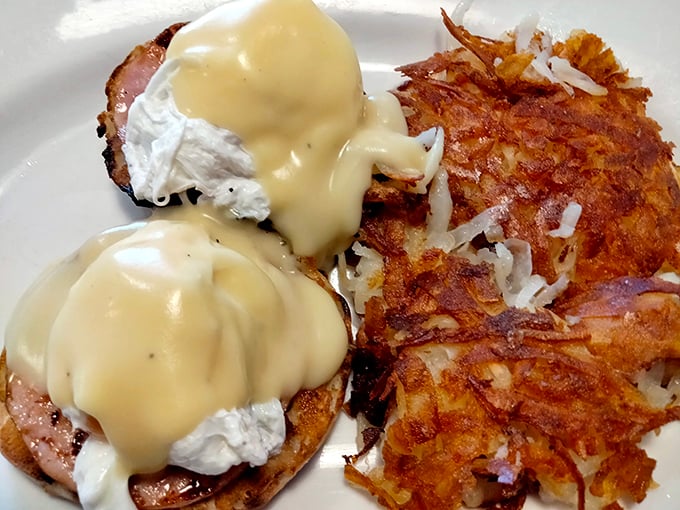 Eggs Benedict: the breakfast aristocrat that makes ordinary mornings impossible. Those hash browns are the unsung heroes of the plate.