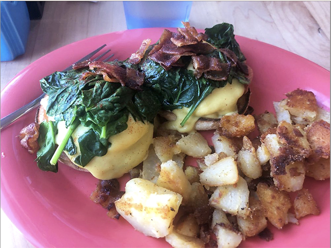 Eggs Benedict elevated with sautéed spinach and bacon, because brunch should always feel like a special occasion.