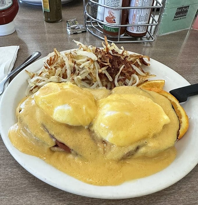 Eggs Benedict done diner-style: no pretension, just hollandaise sauce generous enough to make you consider licking the plate when nobody's looking.
