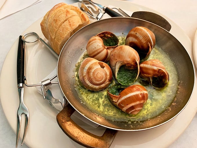 Escargot swimming in garlic butter—proof that anything becomes delicious when given the French treatment. That baguette isn't just a side, it's an essential butter-delivery system.