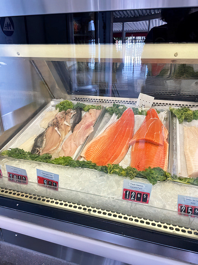 The fish market case—where tomorrow's dinner displays itself with pride. These fillets are so fresh they practically need their own Instagram accounts.