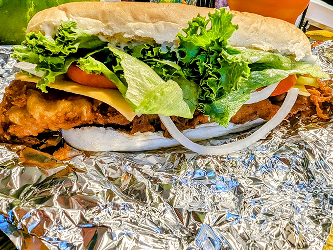 A sandwich that demands two hands and zero distractions—crispy fish, fresh veggies, and a bun that knows its supporting role.