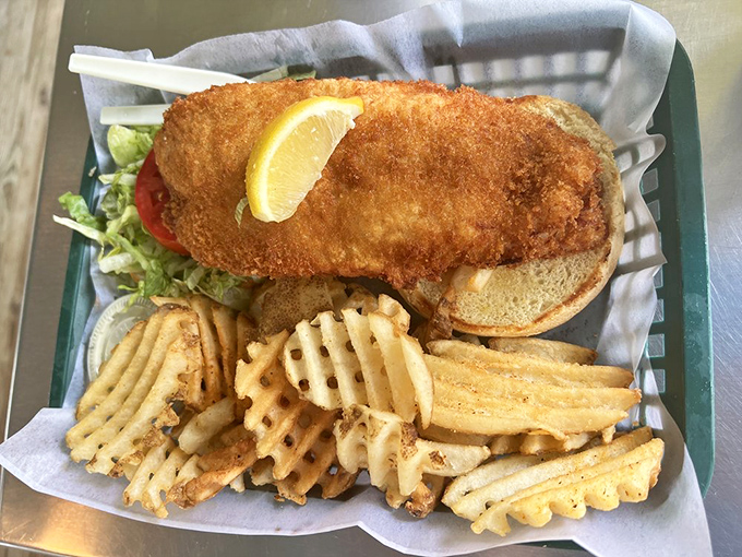 The golden-fried fish sandwich that launched a thousand return visits. Crispy exterior, flaky interior, and those waffle fries deserve their own fan club.