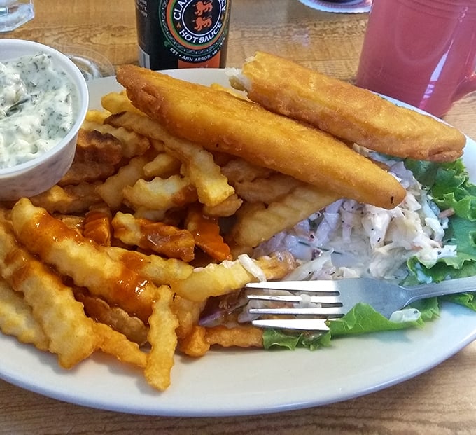 Fish and chips that would make the British proud, with a golden batter jacket protecting flaky white fish. The tartar sauce looks homemade—bonus points!