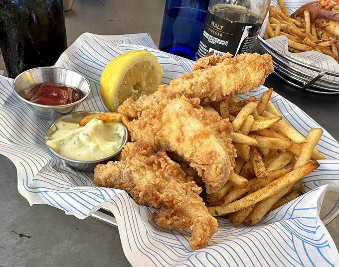 Fish and chips that would make a British pub jealous—golden, crispy batter protecting flaky white fish, with fries worthy of their own fan club.
