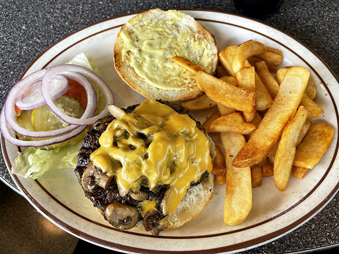 A burger that doesn't need fancy toppings to impress, just honest beef, melty cheese, and fries that could make a Frenchman weep with joy.