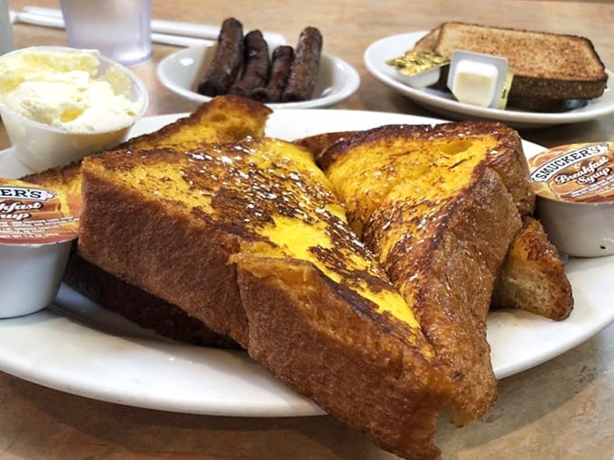 French toast so perfectly golden it belongs in Fort Knox, served with breakfast meats and a side of weekend morning bliss.