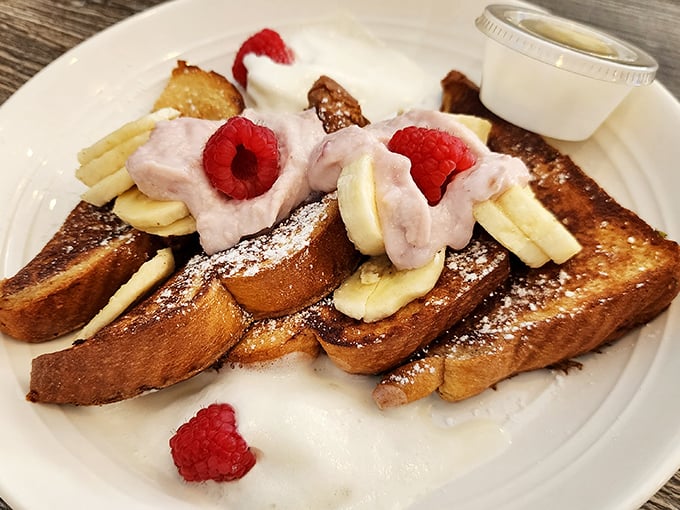 French toast that makes you question all other breakfasts—topped with fresh berries and bananas that practically sing on the plate.