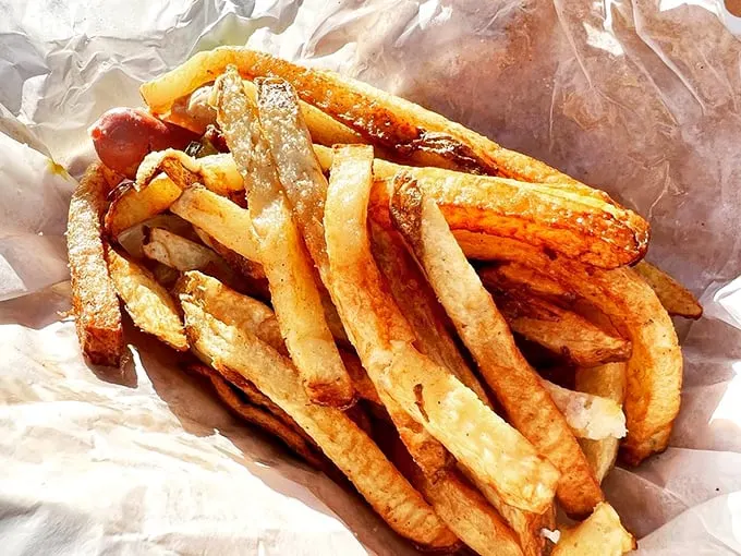 These hand-cut fries aren't just a side dish—they're the supporting actors that sometimes steal the show from the hot dog headliner.