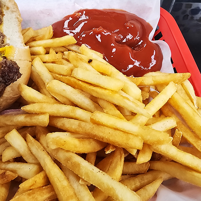 French fries done right—crispy on the outside, fluffy inside, and arranged in a golden pile that whispers, "Clear your afternoon schedule." 