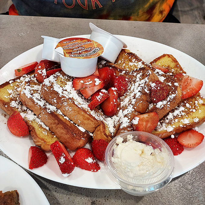 French toast that's dressed for success with powdered sugar snow and fresh strawberries—breakfast that thinks it's dessert, and we're not complaining.