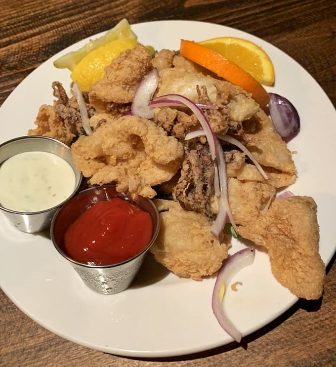 Calamari that defies the rubbery reputation of lesser versions—perfectly golden, tender Monterey Bay squid served with twin dipping sauces because choosing between them would be cruel.