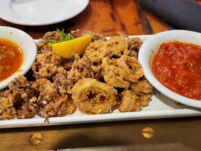 Fried calamari that's crispy on the outside, tender within—served with dipping sauces that make you wonder why you'd eat it any other way.