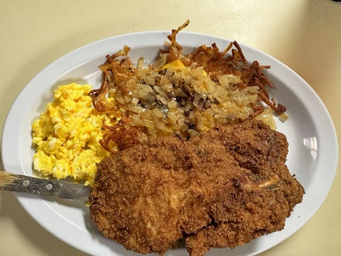 A proper Southern fried pork chop doesn't need fancy garnishes—just a plate big enough to contain its magnificence.