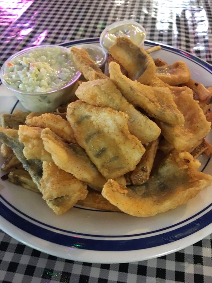 Perfectly breaded fish fillets that shatter with each bite, served alongside creamy coleslaw – proof that simple food done right is worth celebrating.