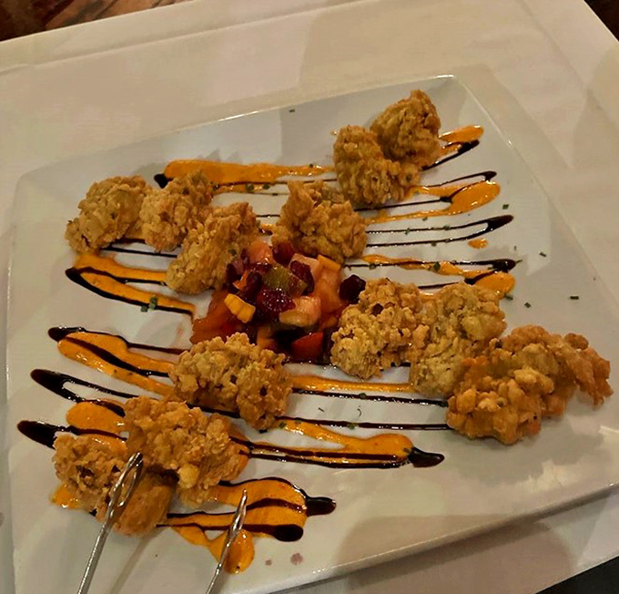 Golden-fried oysters arranged like edible jewelry. The colorful sauces transform this seafood starter into an Instagram-worthy work of art.