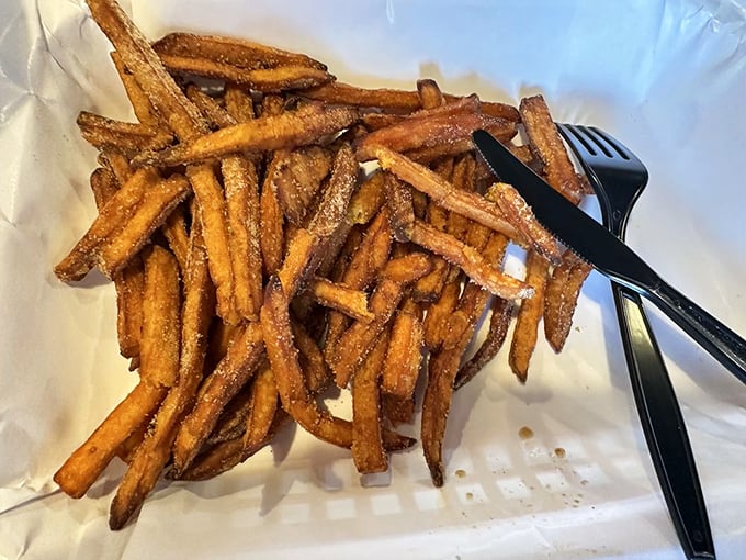 Sweet potato fries that could make a French chef question their life choices—crispy, salty, and somehow both rustic and refined.