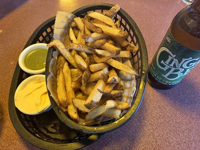 Hand-cut fries that achieve the golden trifecta: crispy exterior, fluffy interior, and just enough salt to make you reach for another cold beer.