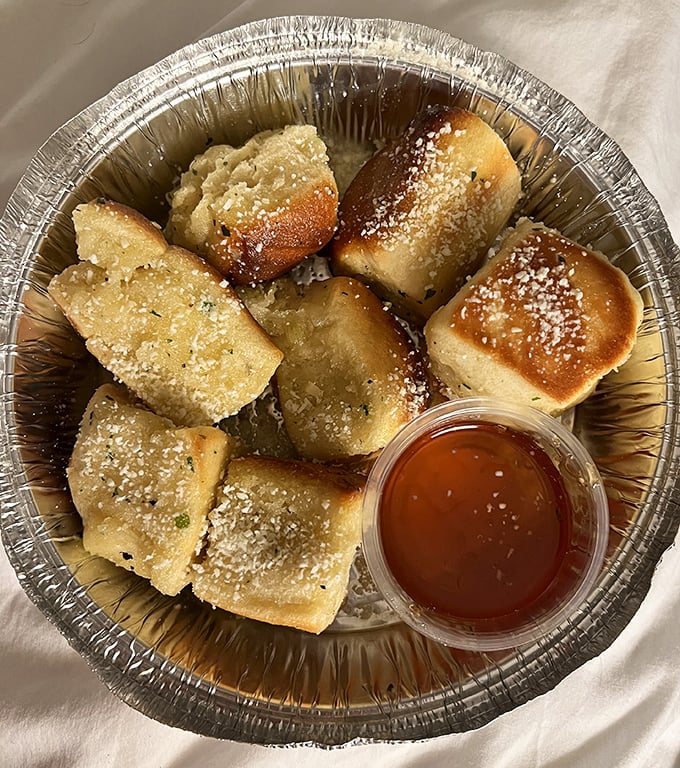 Garlic Pillows dusted with parmesan and served with honey—carbs that deserve their own category in the food pyramid.