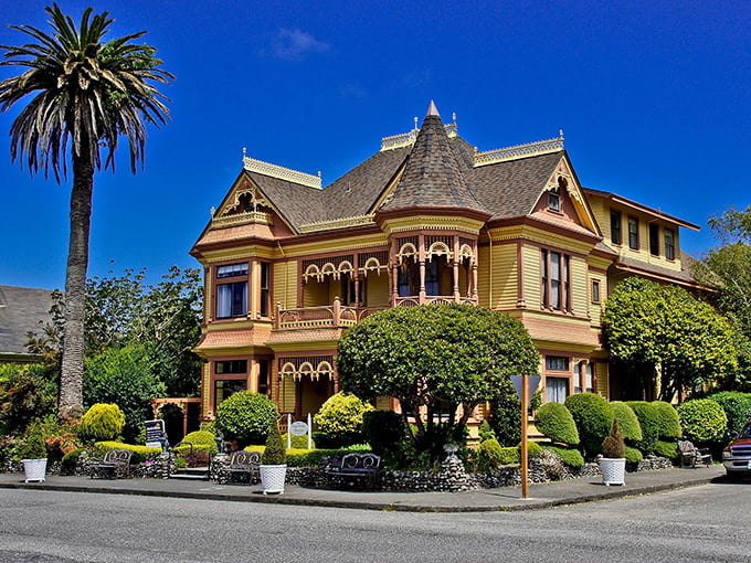 The Gingerbread Mansion isn't just showing off—though with that mustard-yellow paint and white trim, it absolutely could.