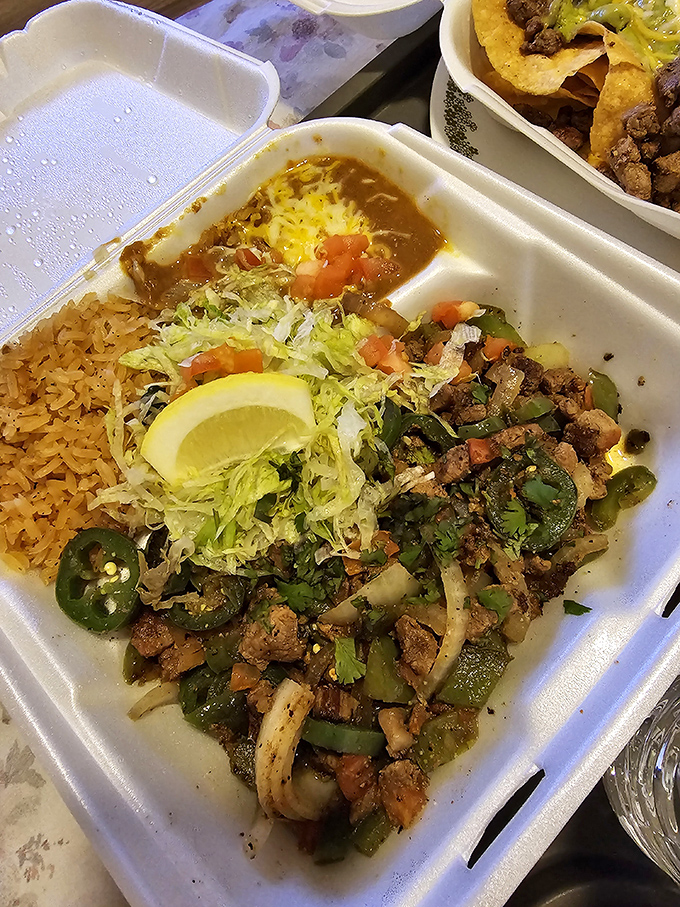 A fiesta in a takeout container. The green chile beef comes with all the fixings and a side of pure joy.