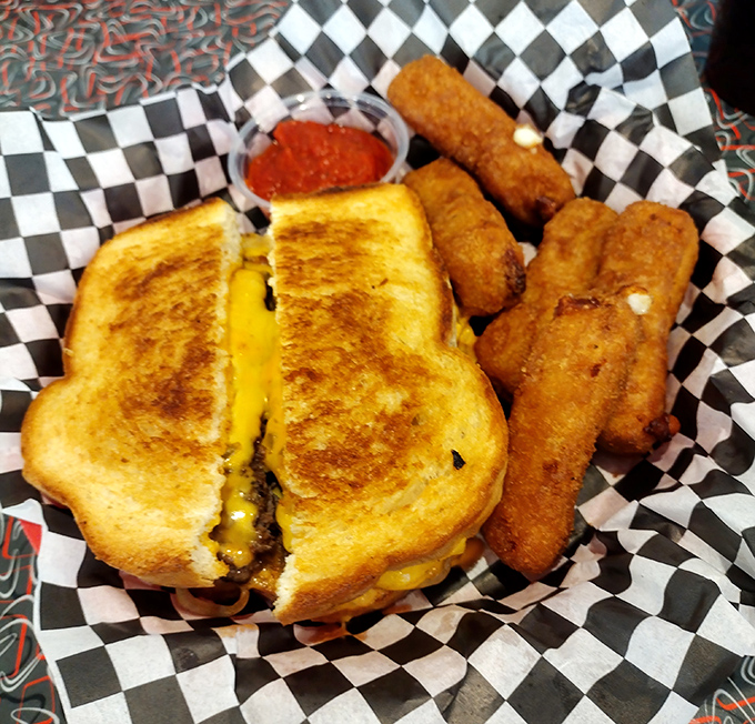 The perfect grilled cheese doesn't exi— Wait, it does! Golden-brown exterior, melty interior, with mozzarella sticks standing guard alongside.