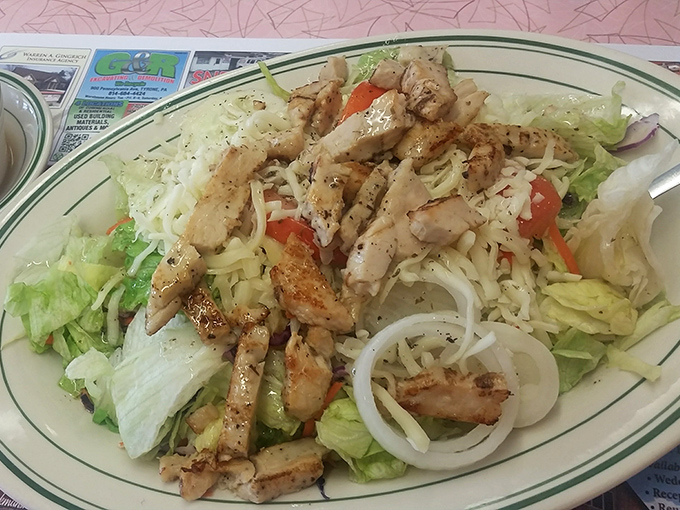 A grilled chicken salad that actually satisfies. No sad desk lunch here—just perfectly seasoned chicken atop crisp lettuce that doesn't apologize for being healthy.
