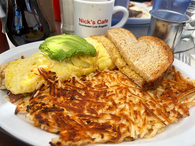 Golden hash browns with the perfect crisp-to-tender ratio, alongside an omelet and avocado—the breakfast holy trinity of Los Angeles.