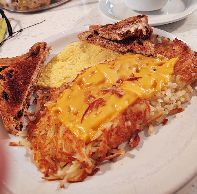 Hashbrowns wearing a melted cheese tuxedo – the kind of breakfast sidekick that deserves its own fan club and commemorative t-shirt.