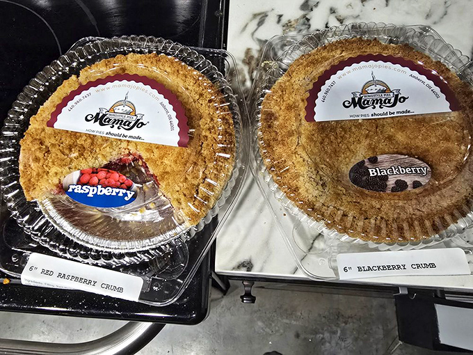 Berry pies with perfect crumb toppings await their forever homes—these aren't just desserts, they're adoption-worthy treasures.