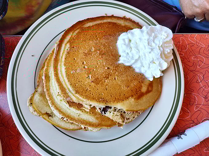 Golden pancakes with a dollop of whipped cream—the breakfast equivalent of a perfect sunset. Simple pleasures at their finest.
