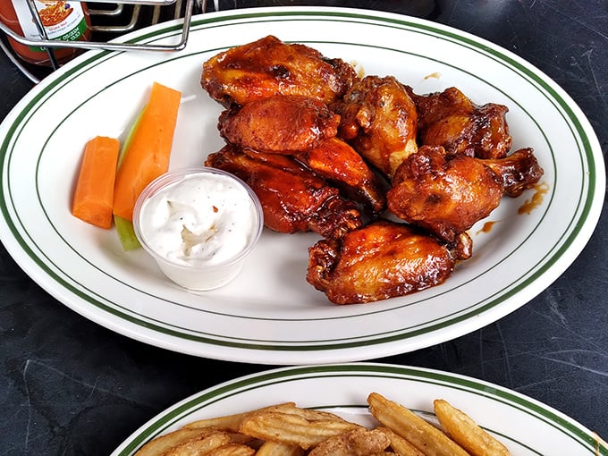 Wings glazed to glossy perfection, accompanied by cooling ranch and crisp carrots – a holy trinity of bar food excellence.