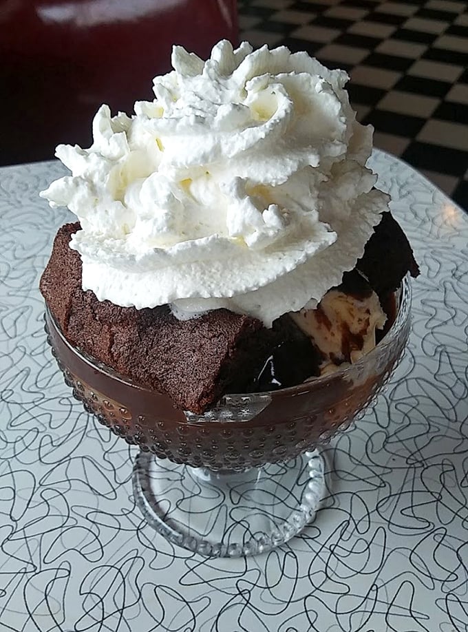 Hot fudge cake that makes diets spontaneously combust within a 10-foot radius. That mountain of whipped cream deserves its own zip code.
